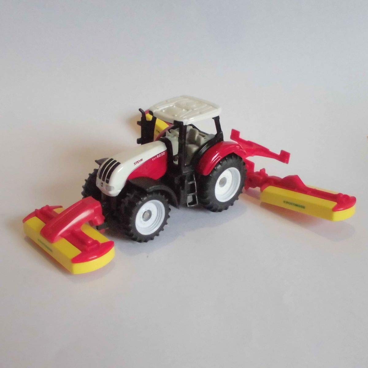 siku 1672, Steyr Traktor mit Pöttinger Mähwerkskombination, Metall/Kun ...
